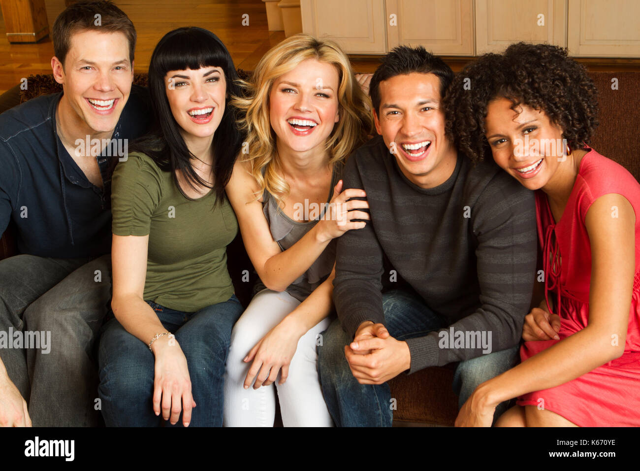 Diverse group of friends talking and laughing Stock Photo - Alamy