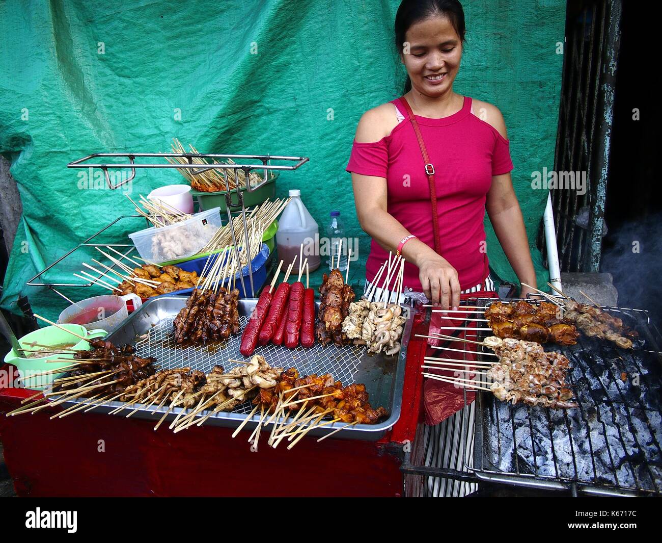 ANTIPOLO CITY, PHILIPPINES - SEPTEMBER 7, 2017: A street food vendor ...