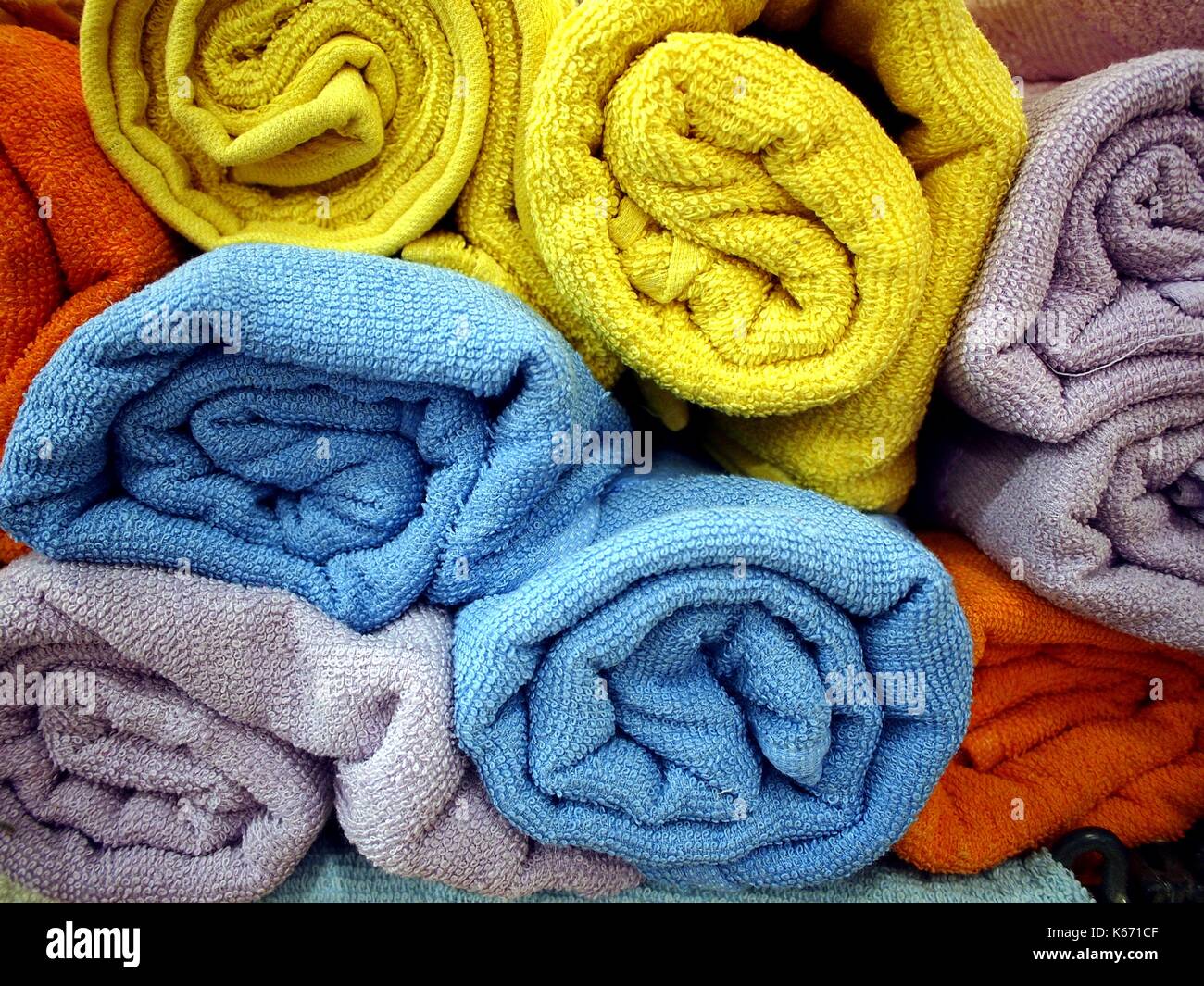 Photo of a stack of rolls of colorful bath towels Stock Photo - Alamy