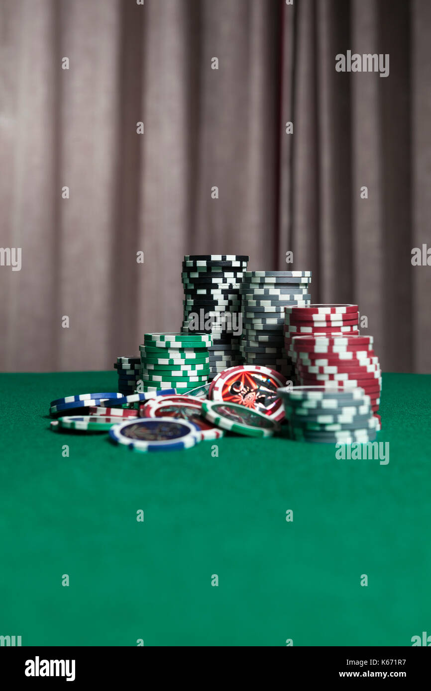 Colorful poker chips on green background Stock Photo - Alamy