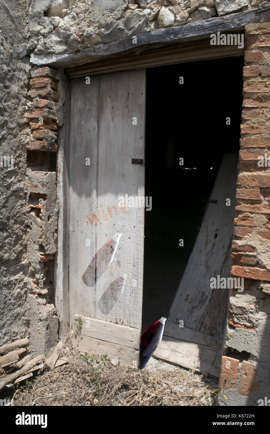 ruined door of an old cellar with a red wine bottle Stock Photo - Alamy