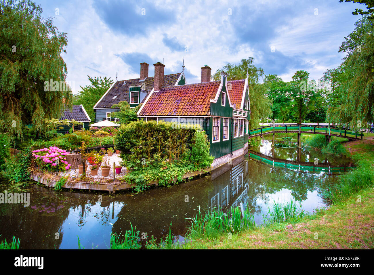 Traditional village with dutch windmills and river at sunset, Holland ...