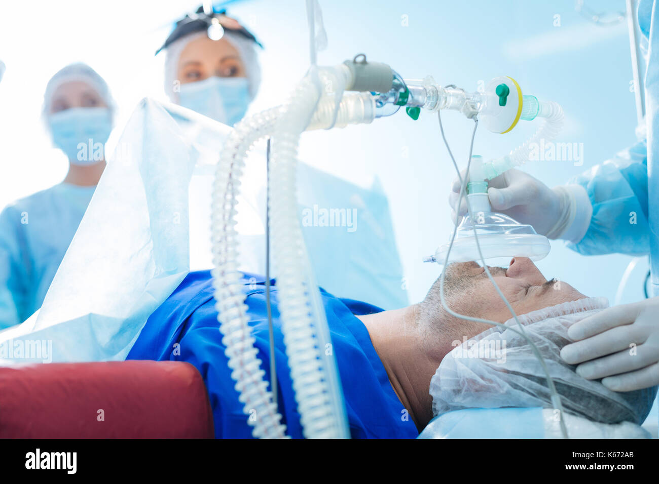 Sick man lying on surgical table Stock Photo - Alamy