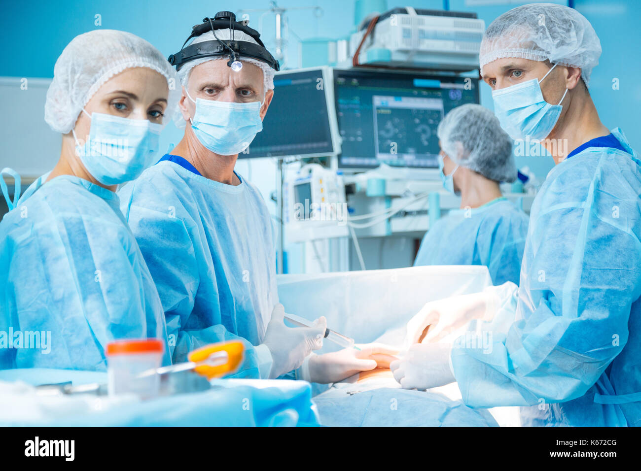 Group of serious medical workers doing operation Stock Photo - Alamy