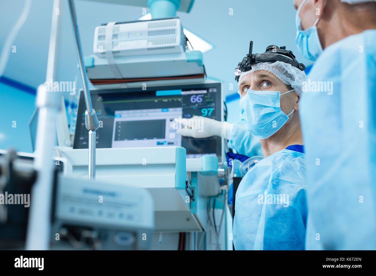 Competent medical worker pointing at his equipment Stock Photo - Alamy