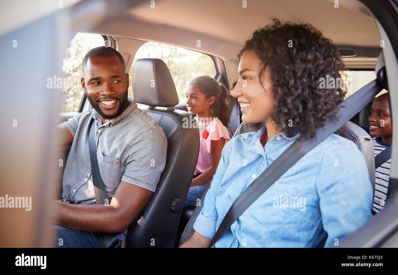 Young black family in a car on a road trip smiling Stock Photo - Alamy