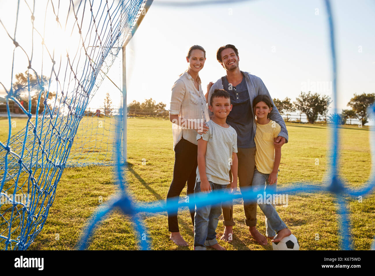 Portrait of a young family during a football game Stock Photo - Alamy
