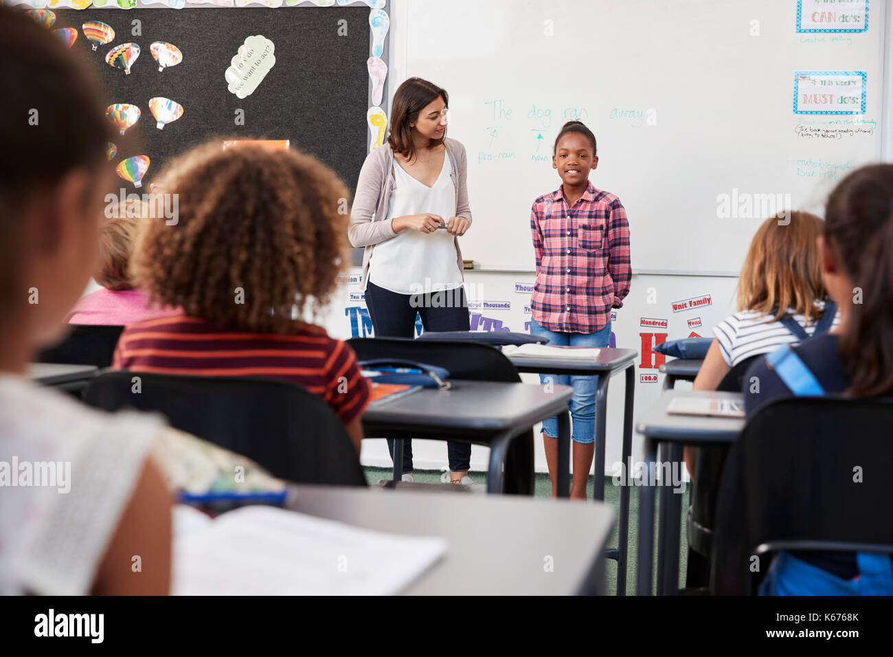 Two students desk teacher standing hi-res stock photography and images ...