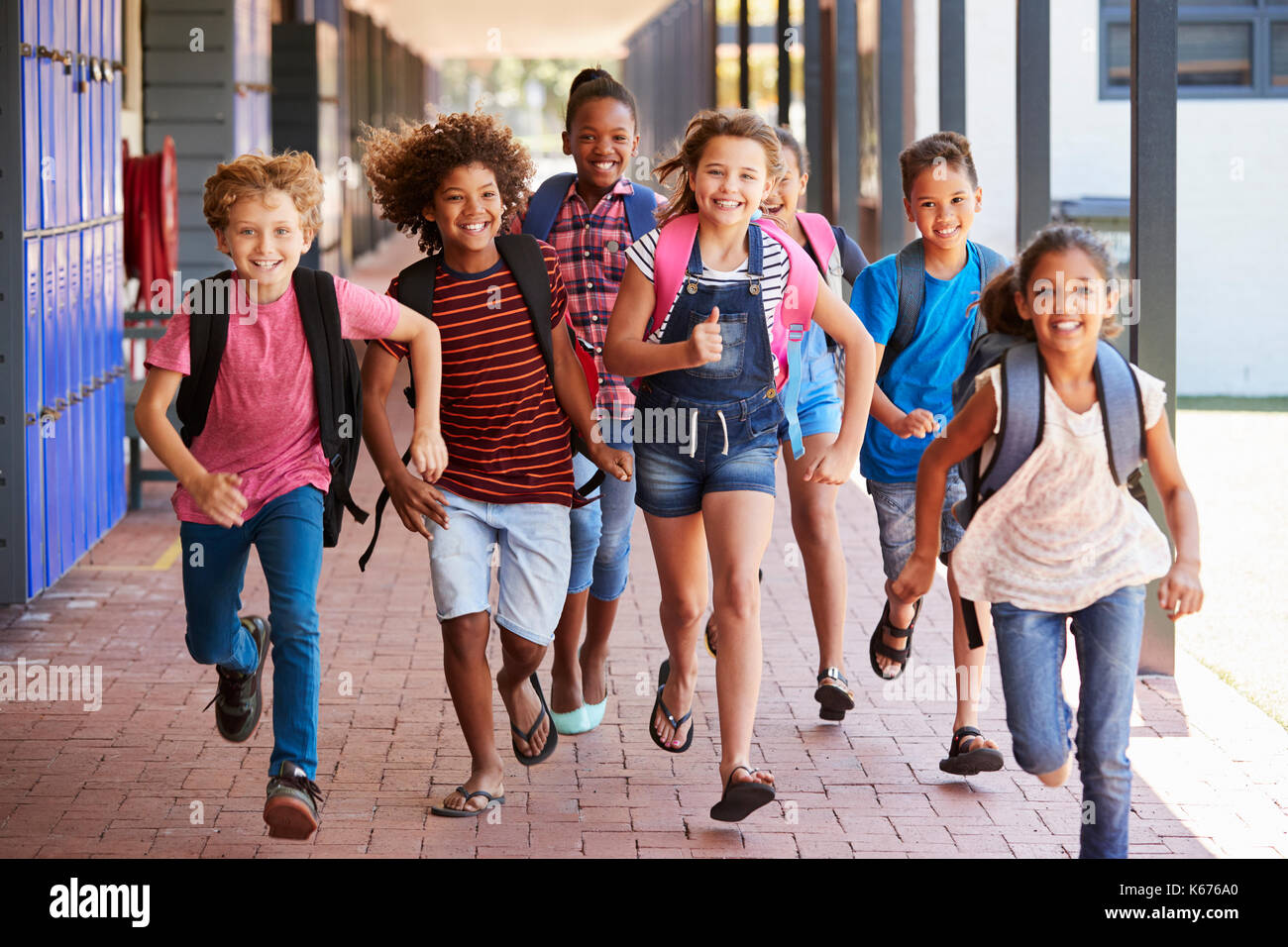 School kids running in elementary school hallway, front view Stock ...