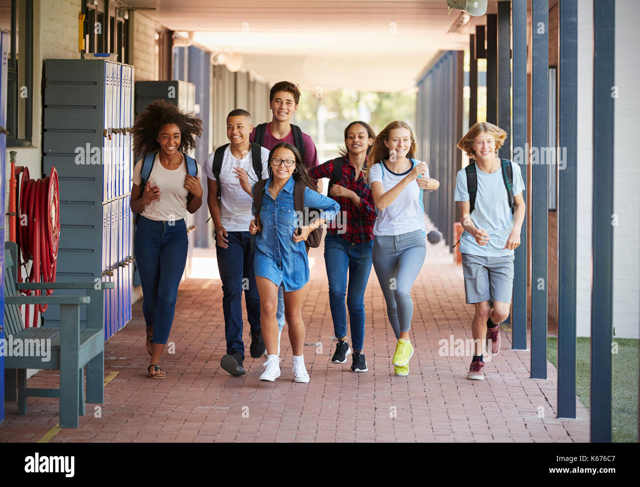 Teenager school kids running in high school hallway Stock Photo - Alamy