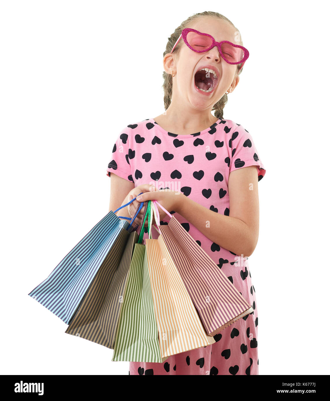 pretty little girl yawns with shopping bag, studio portrait, dressed in ...