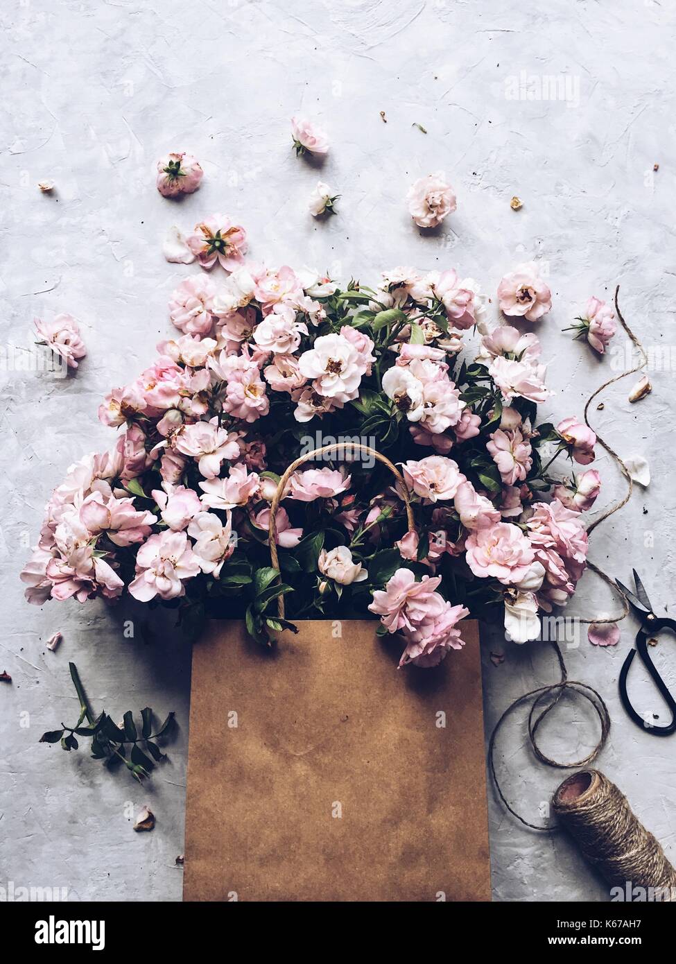 Pink flowers in a paper bag Stock Photo - Alamy