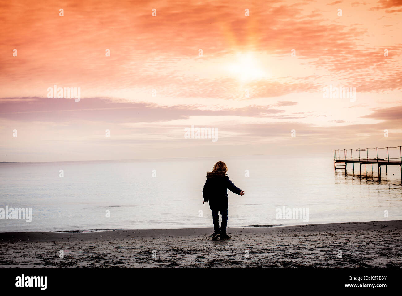 Boy throwing pebbles into the sea hi-res stock photography and images ...