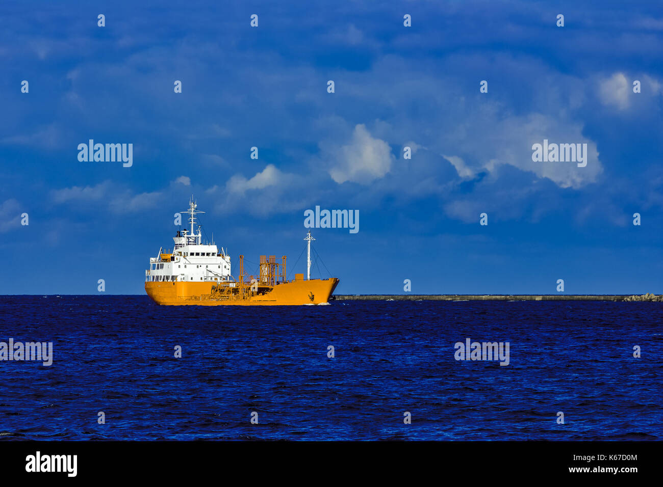 Yellow cargo tanker ship moving at the clear summer day Stock Photo - Alamy