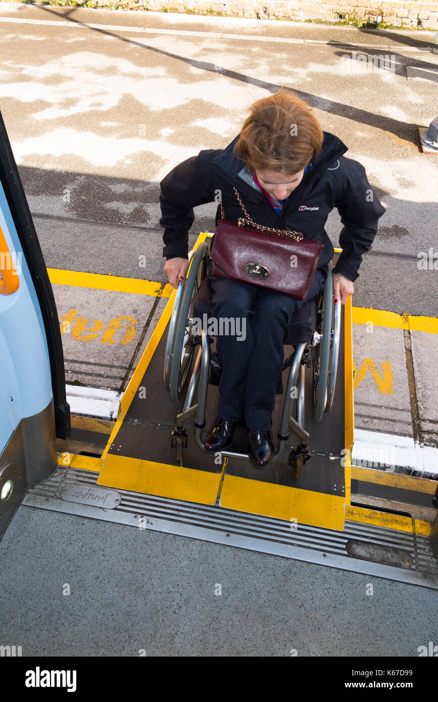 Wheel chair user / person in a wheelchair boarding a train carriage ...
