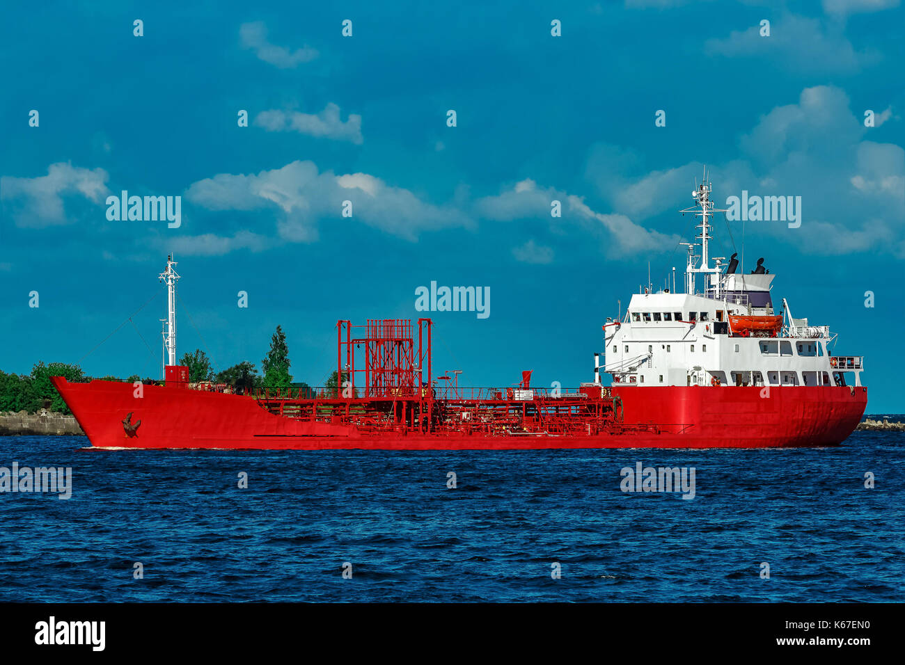 Red cargo tanker ship moving by the river Stock Photo - Alamy