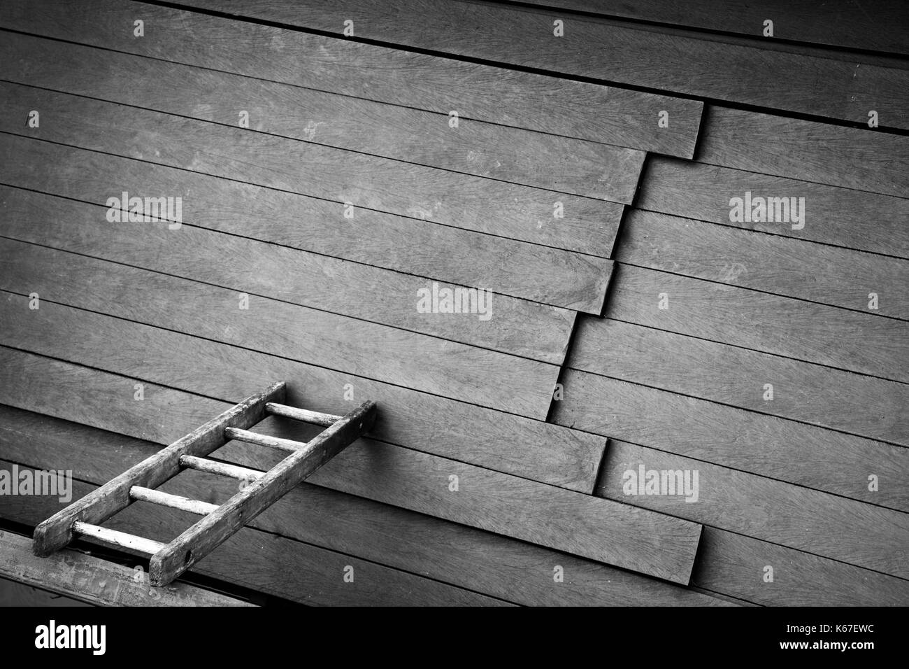 Snake & Ladder - A ladder descends onto a wooden boat deck Stock Photo ...