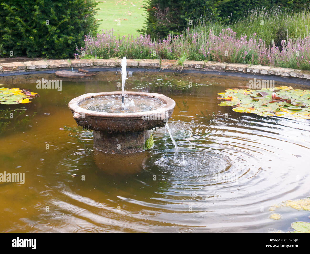 close up of flowing fountain outside in garden ; England; UK Stock ...