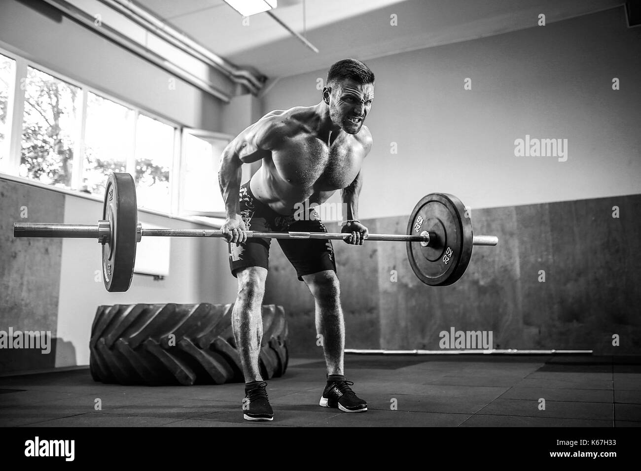 Muscular man lifting barbell Black and White Stock Photos & Images - Alamy