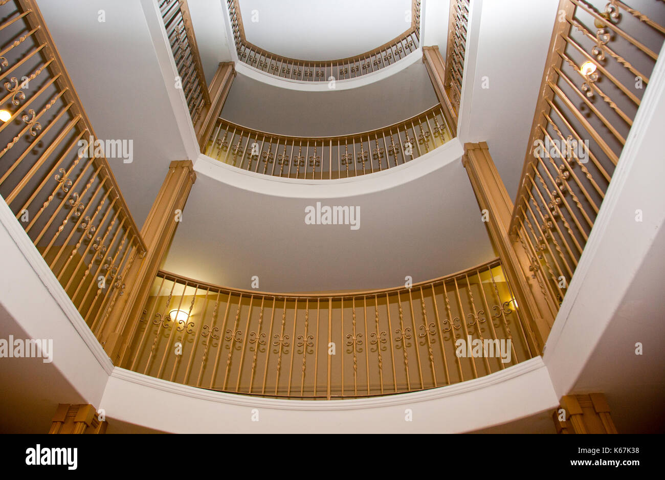 inside a building, apartment or condo lobby staircase with a gold ...