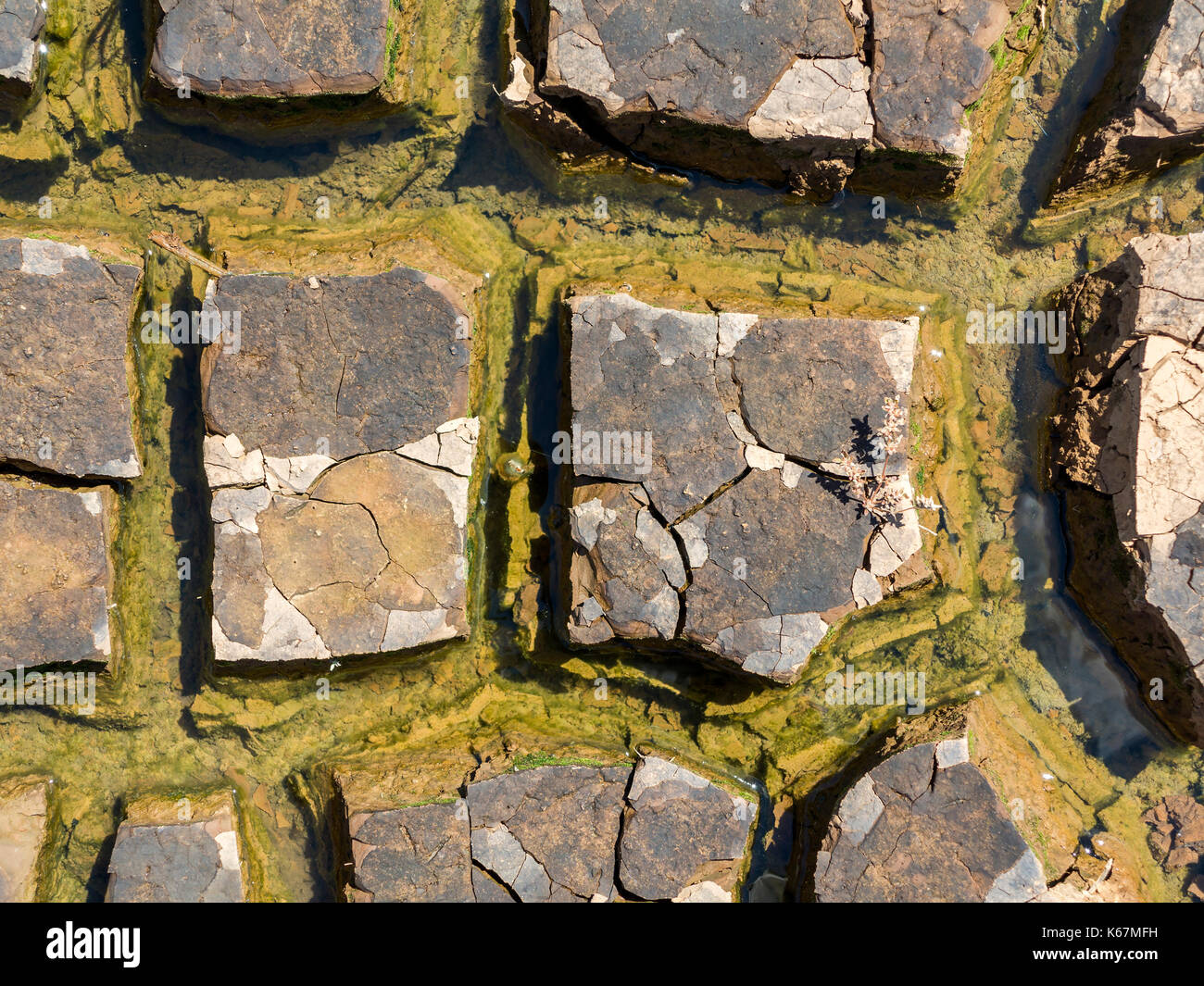 close up detail of cracked ground with water of an empty dam during the ...