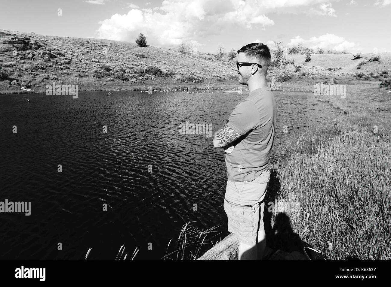 Man staring at lake Stock Photo - Alamy