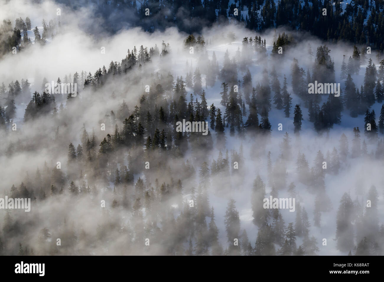 Aerial landscape view of the snow and cloud covered mountain range ...