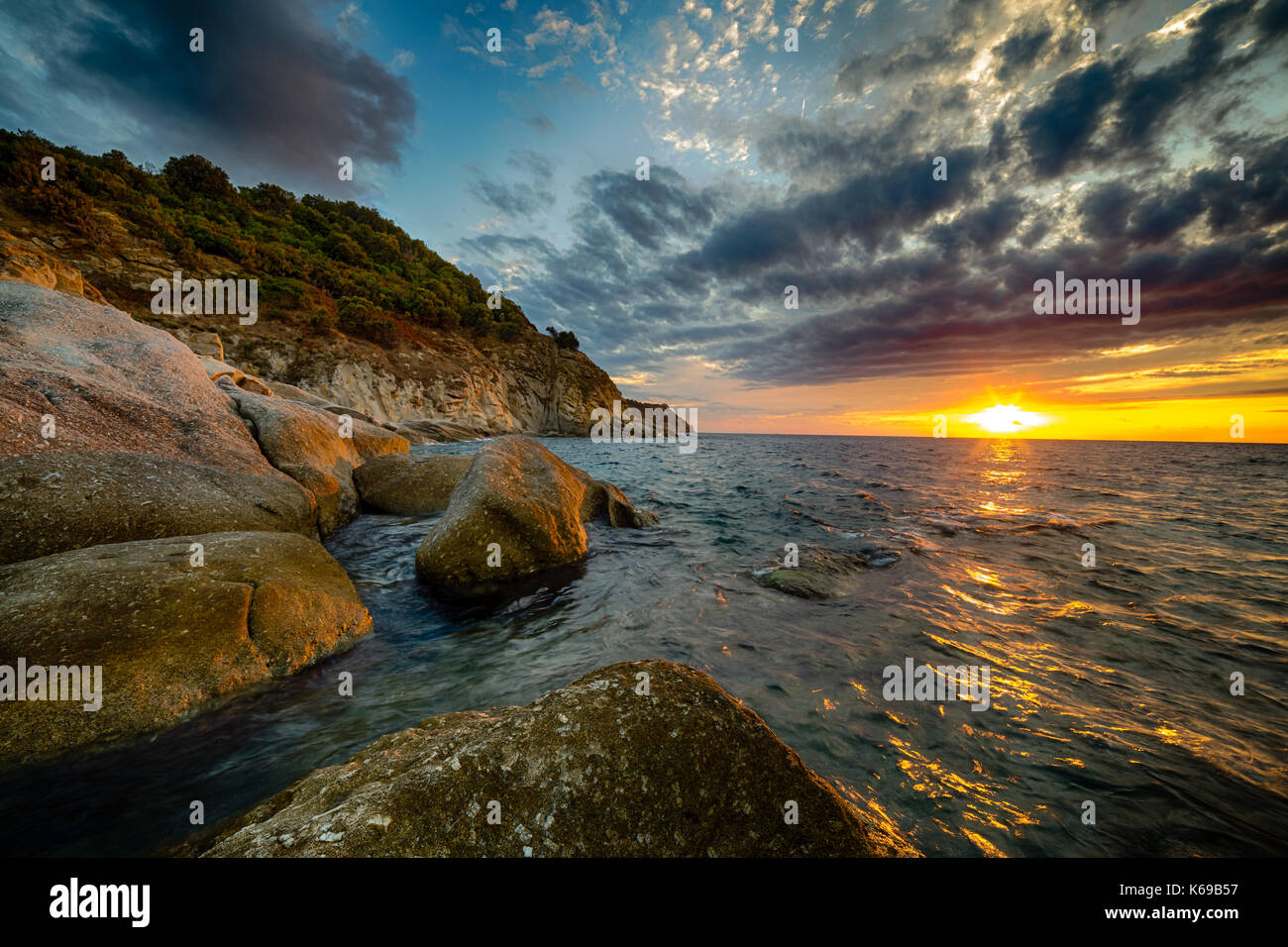 Scenic coastal sunset with orange light on island of Elba Stock Photo ...