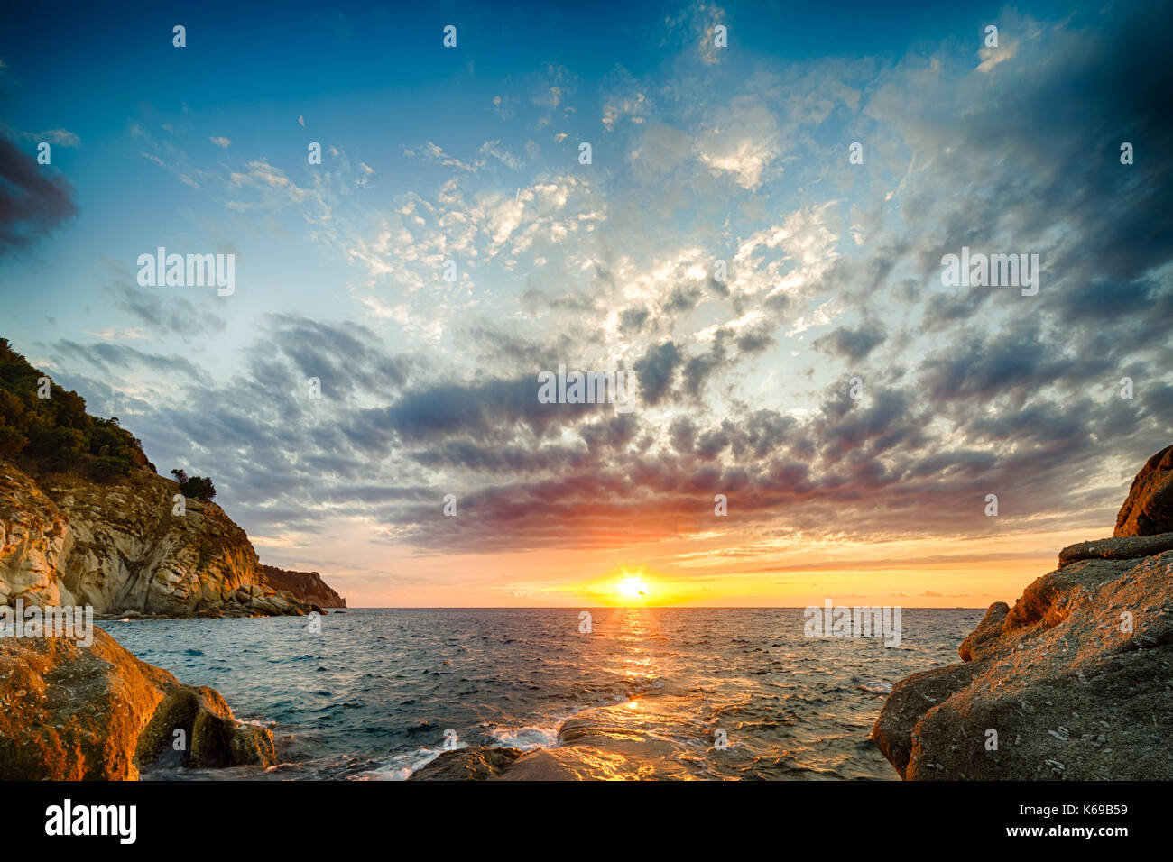 Scenic coastal sunset with orange light on island of Elba Stock Photo ...