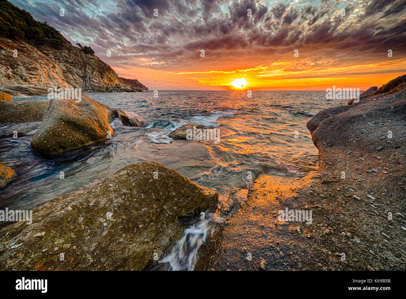Scenic coastal sunset with orange light on bay of Saint Andrew in ...
