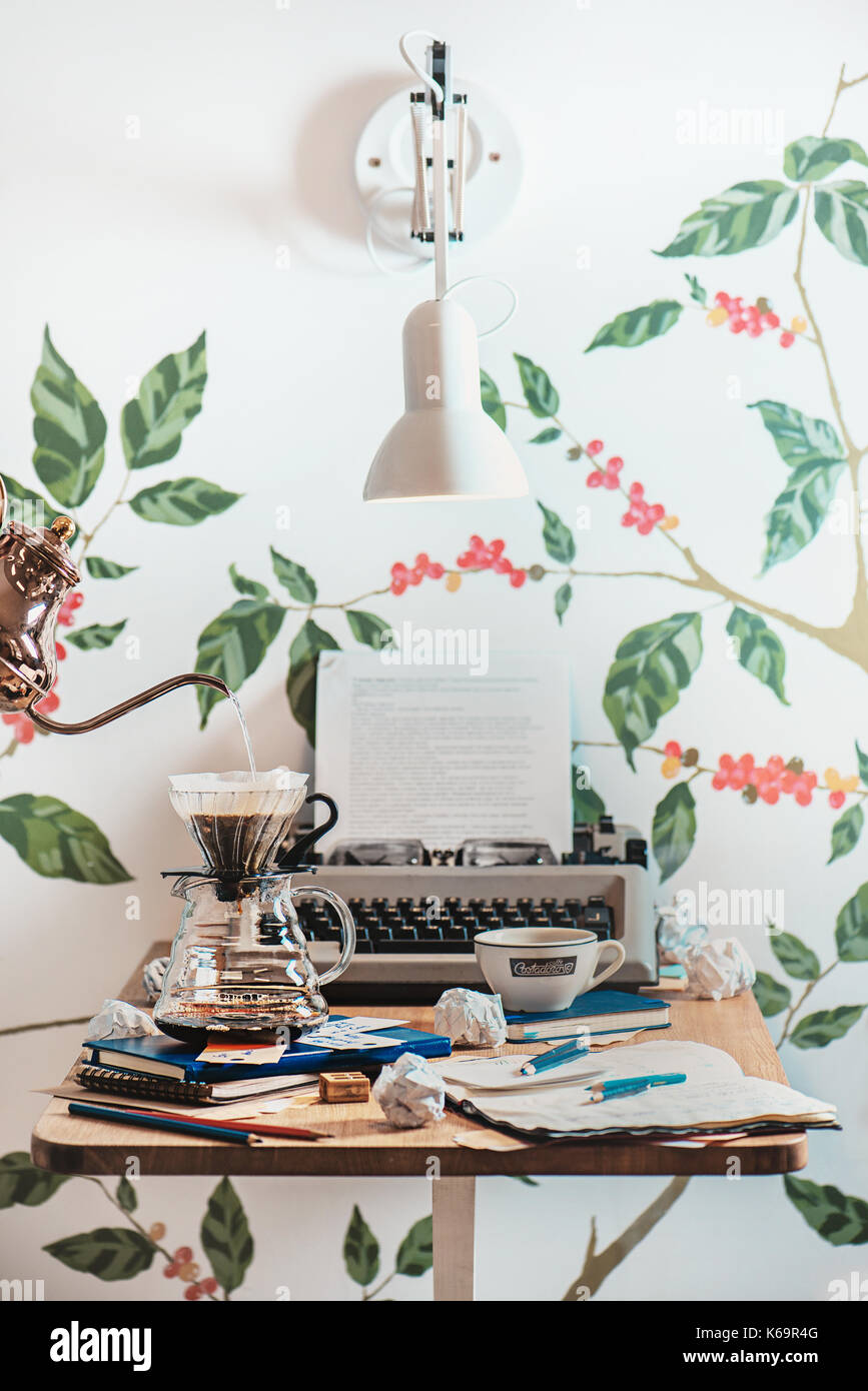 Writer workplace in a cafe with a typewriter, drafts, crumpled paper ...