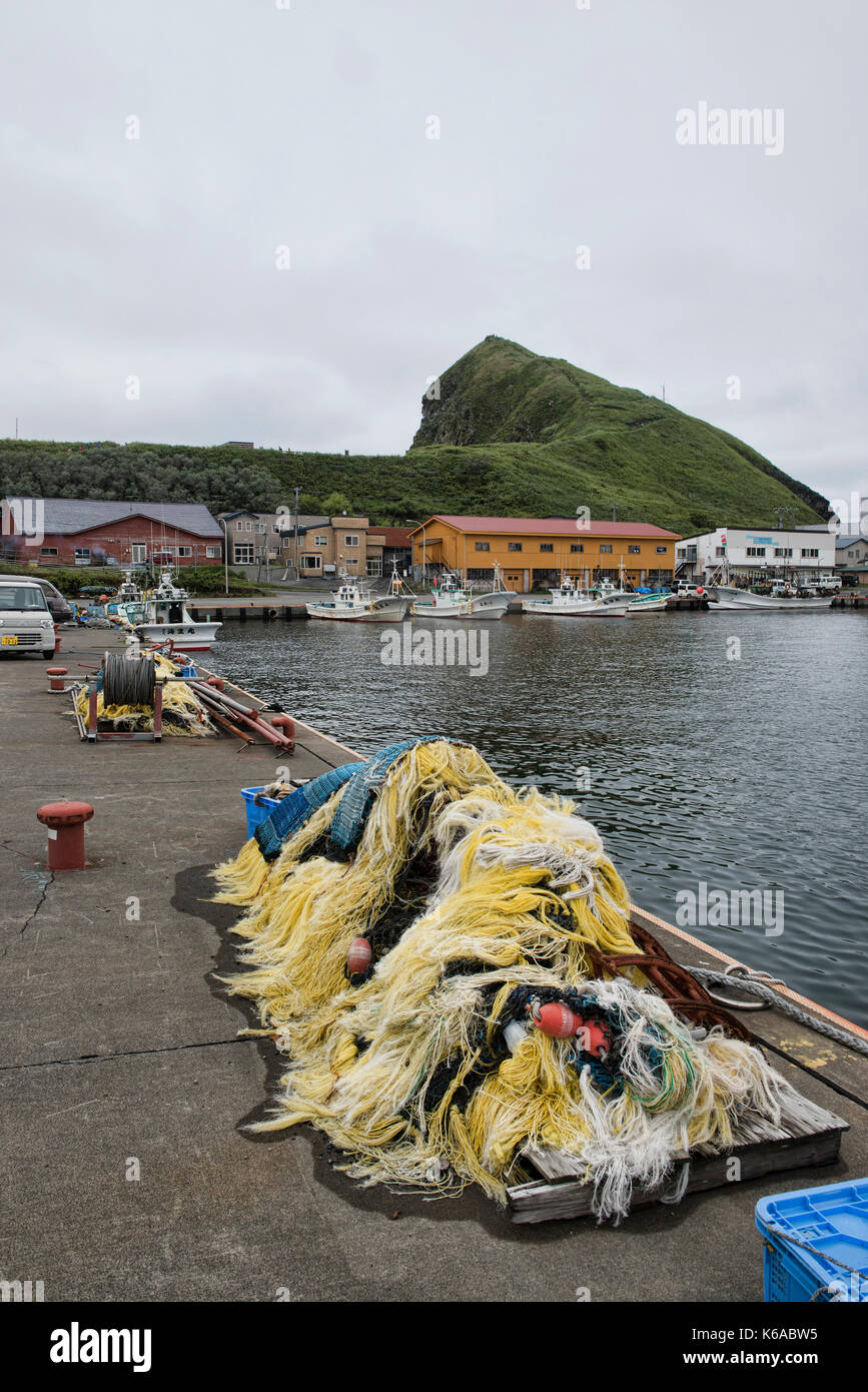 Cape Peshi rises above the Oshidomari port on Rishiri Island, Hokkaido ...