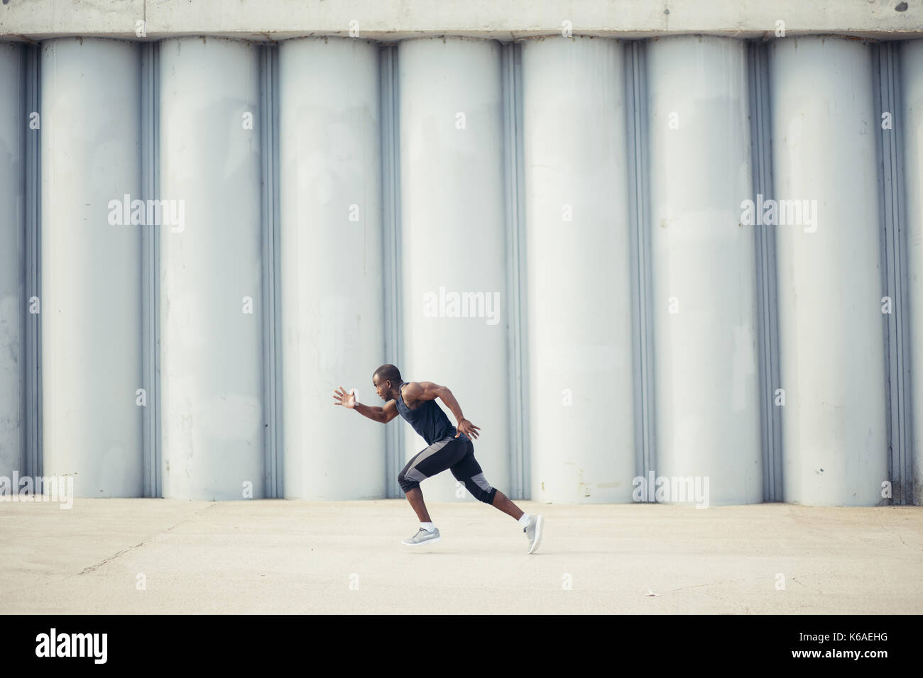 side view of cut Black athlete sprinting on the street Stock Photo - Alamy