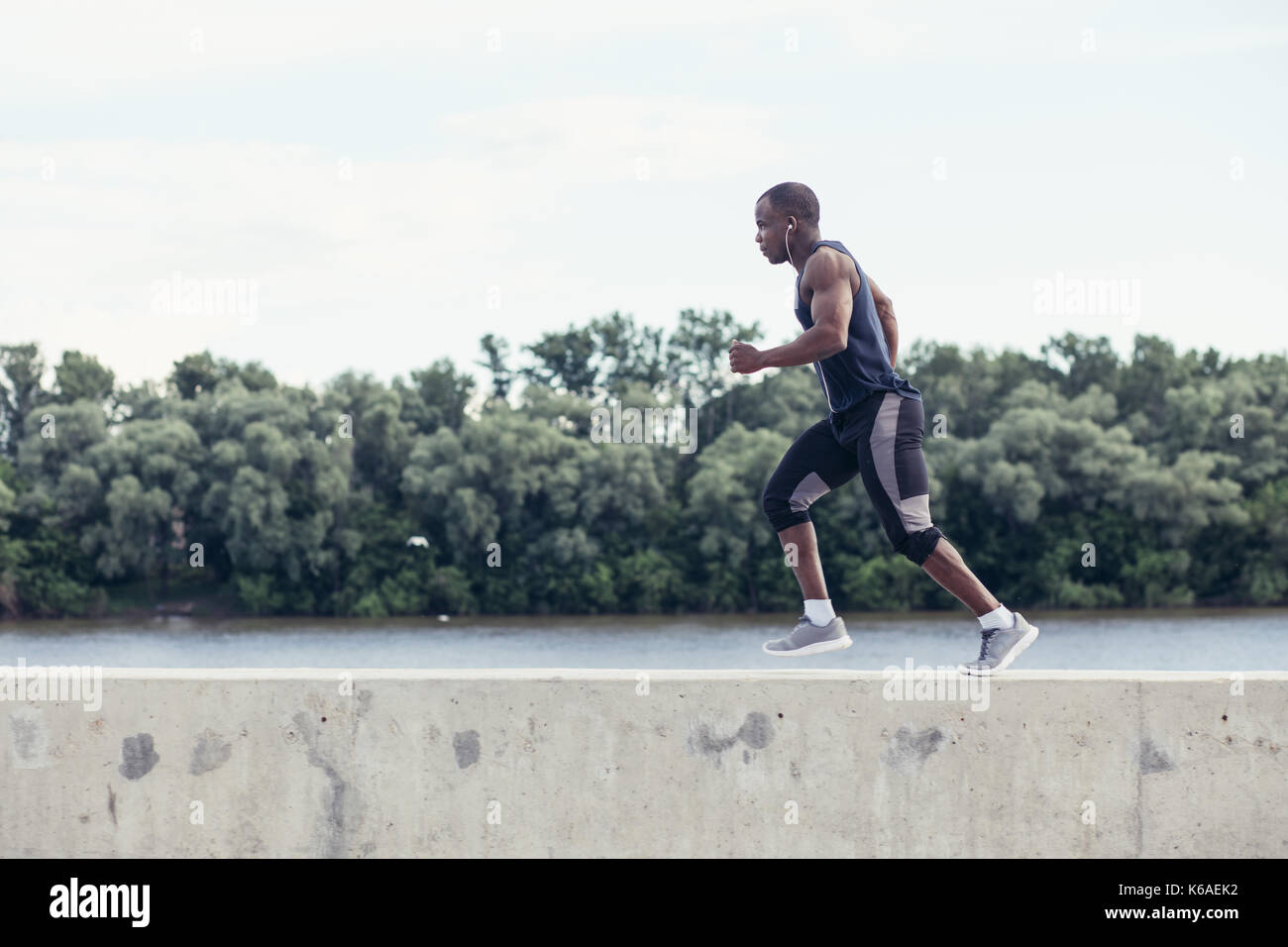 Healthy young athletic man running at the road Stock Photo - Alamy