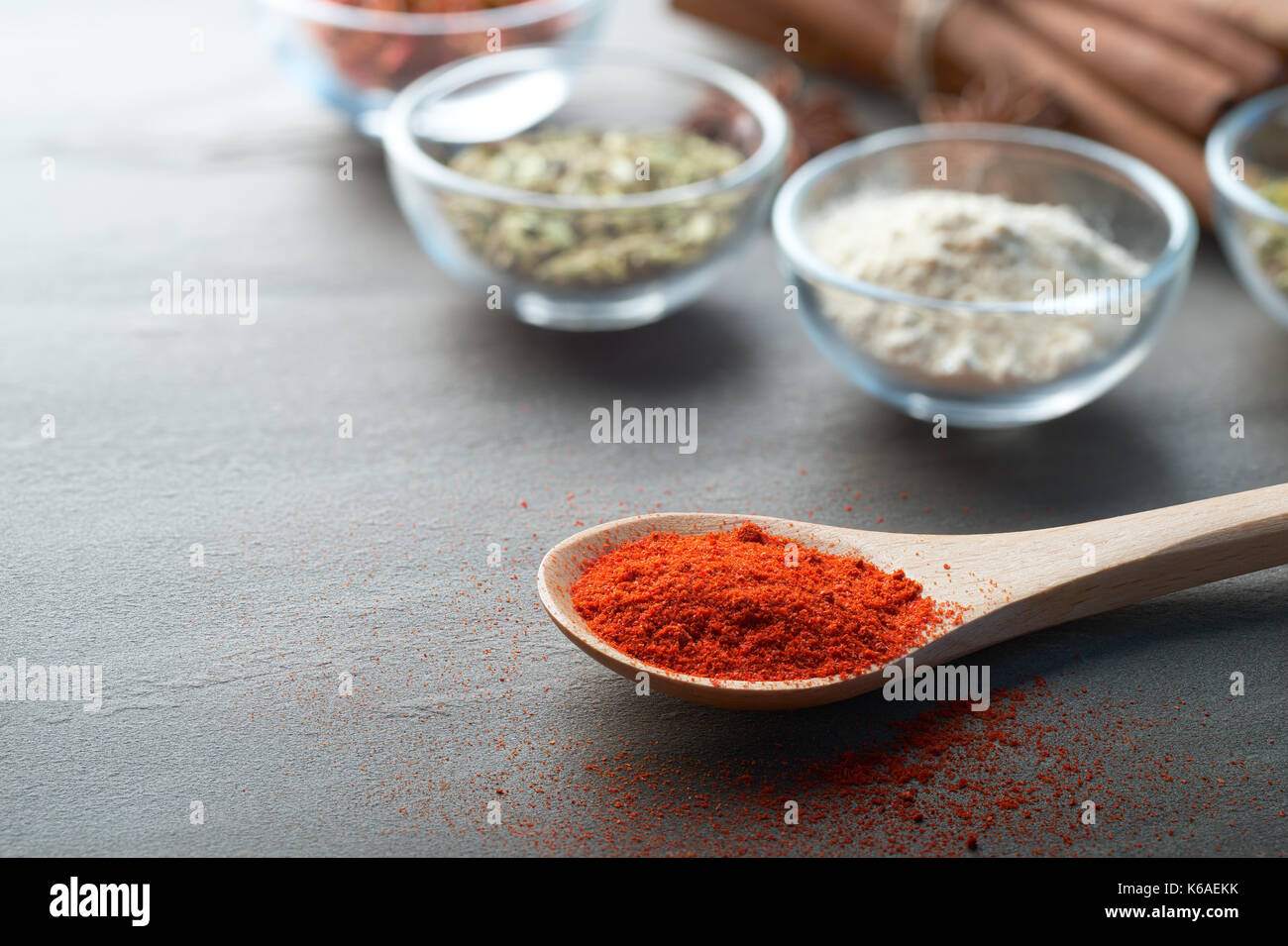 Wooden spoon filled with chili powder and other ingredient Stock Photo ...