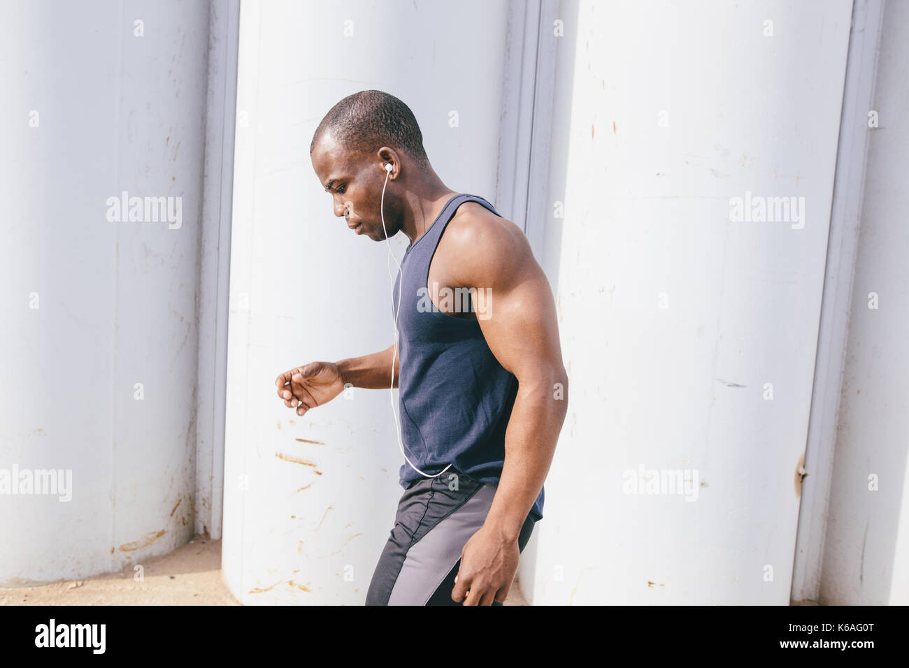 shot of attractive runner with muscular athletic body dressed in black ...