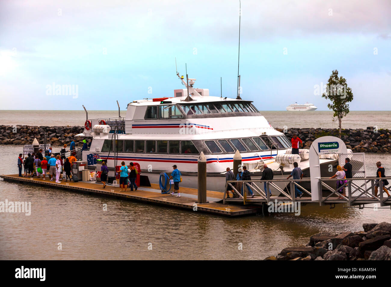 Tourists boarding catamaran for transportation back to cruise ship ...
