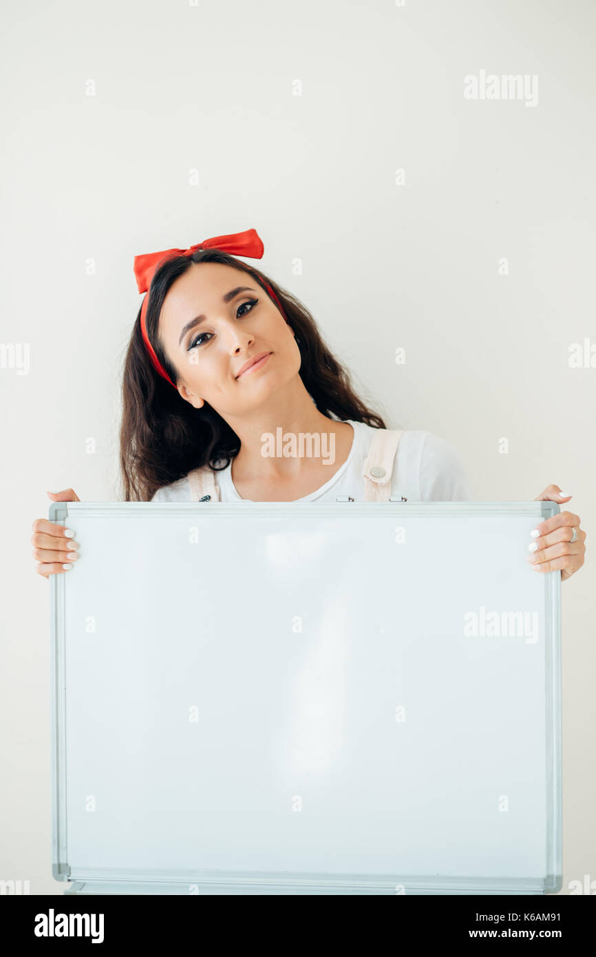 girl smiling and holding a white banner Stock Photo - Alamy