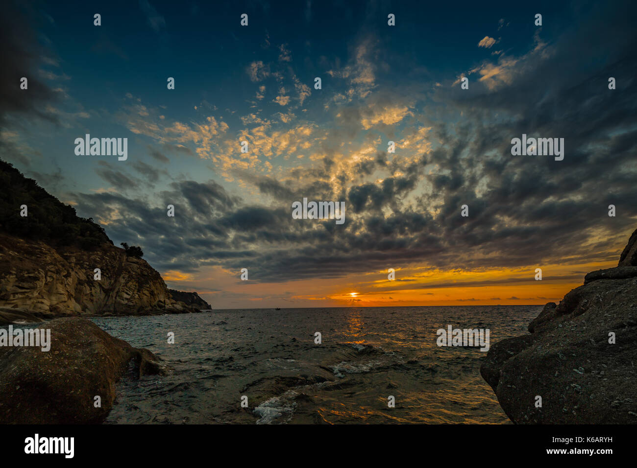 Scenic coastal sunset with orange light on island of Elba Stock Photo ...