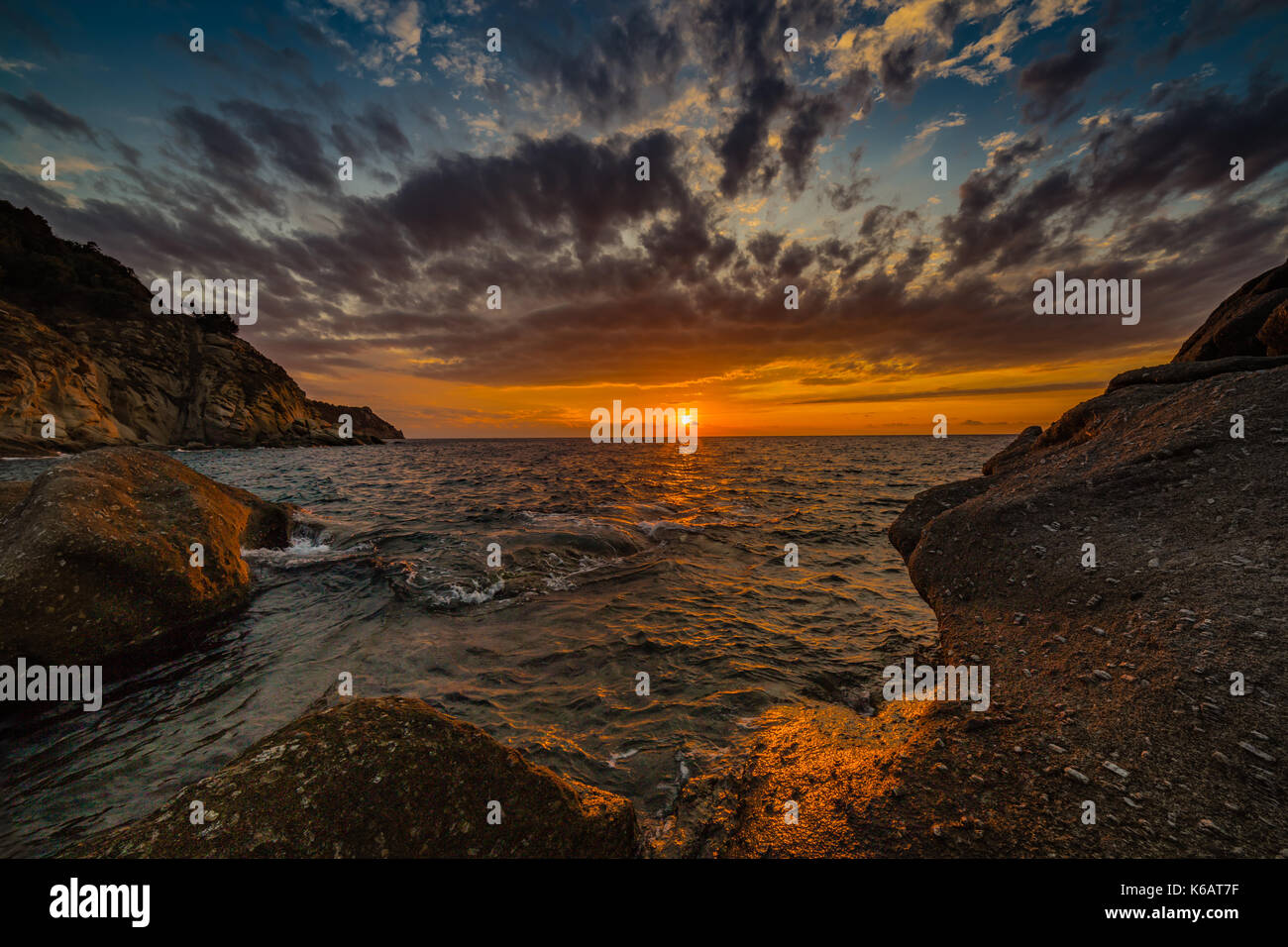Scenic coastal sunset with orange light on island of Elba Stock Photo ...