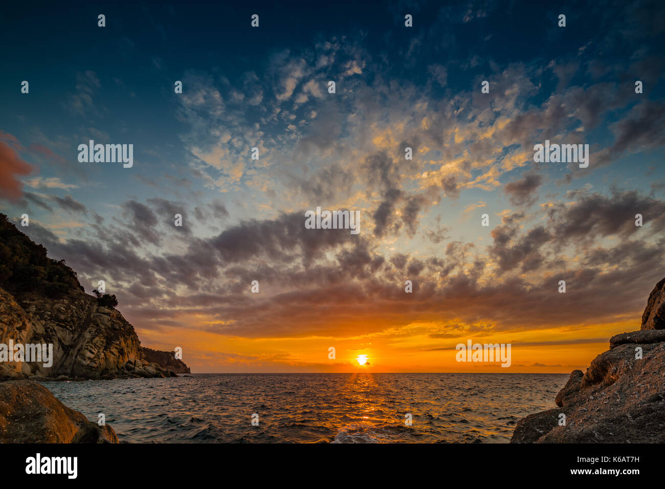 Scenic coastal sunset with orange light on island of Elba Stock Photo ...