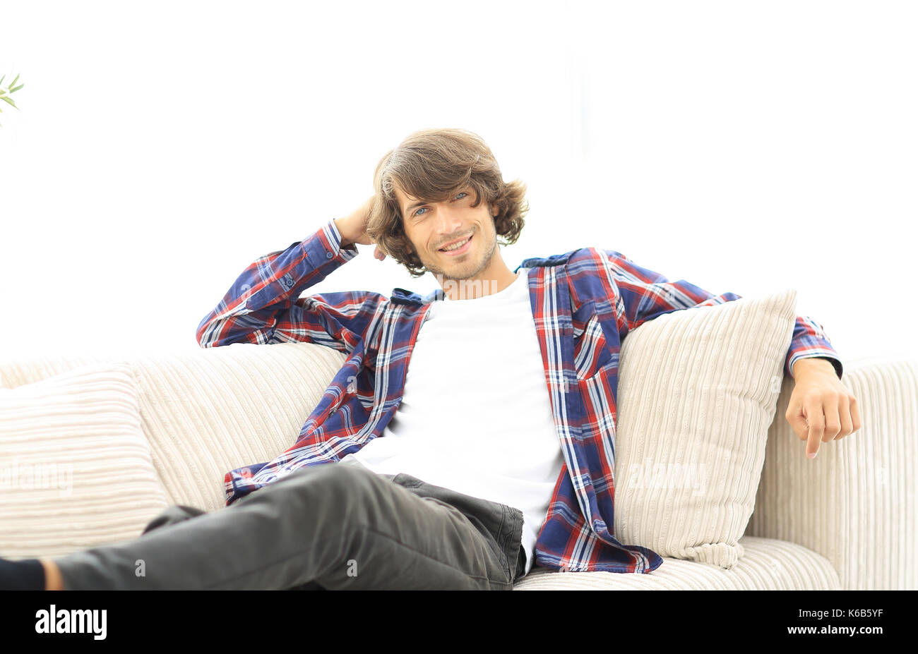 serious modern guy sitting on the couch Stock Photo - Alamy
