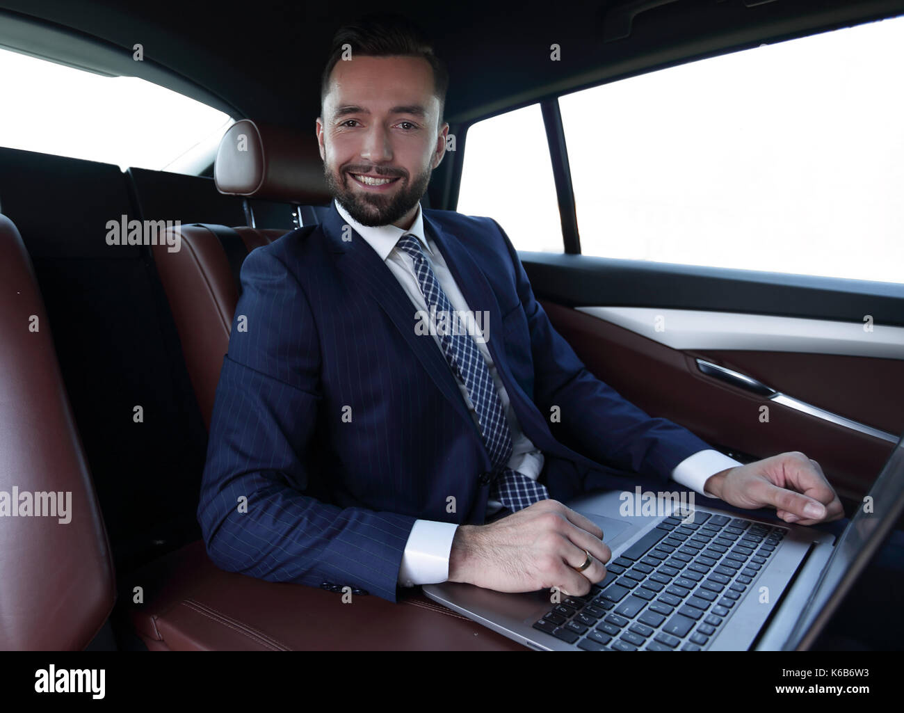 successful man working with laptop sitting in car Stock Photo - Alamy