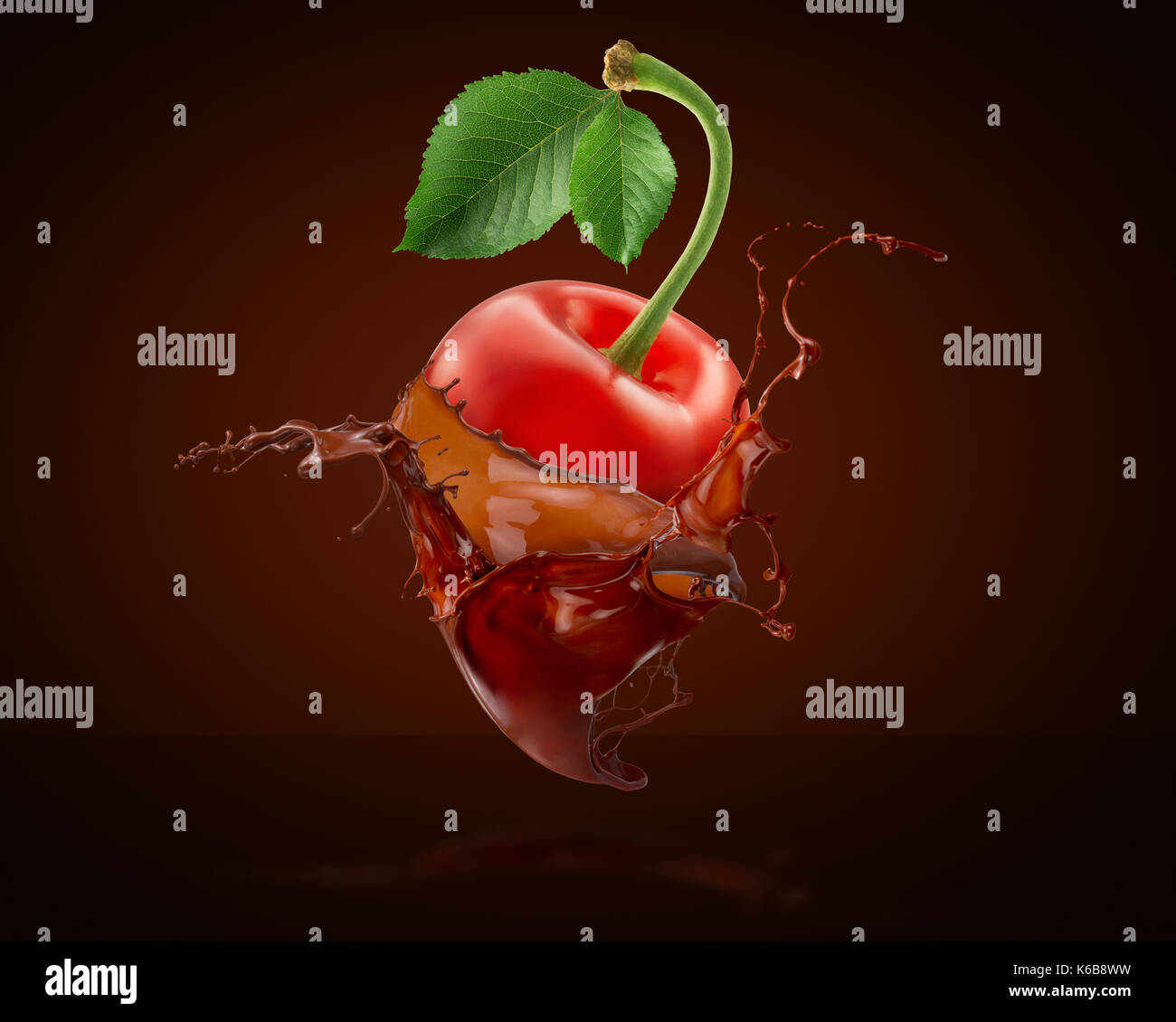 cherry in chocolate splash on a black background Stock Photo - Alamy
