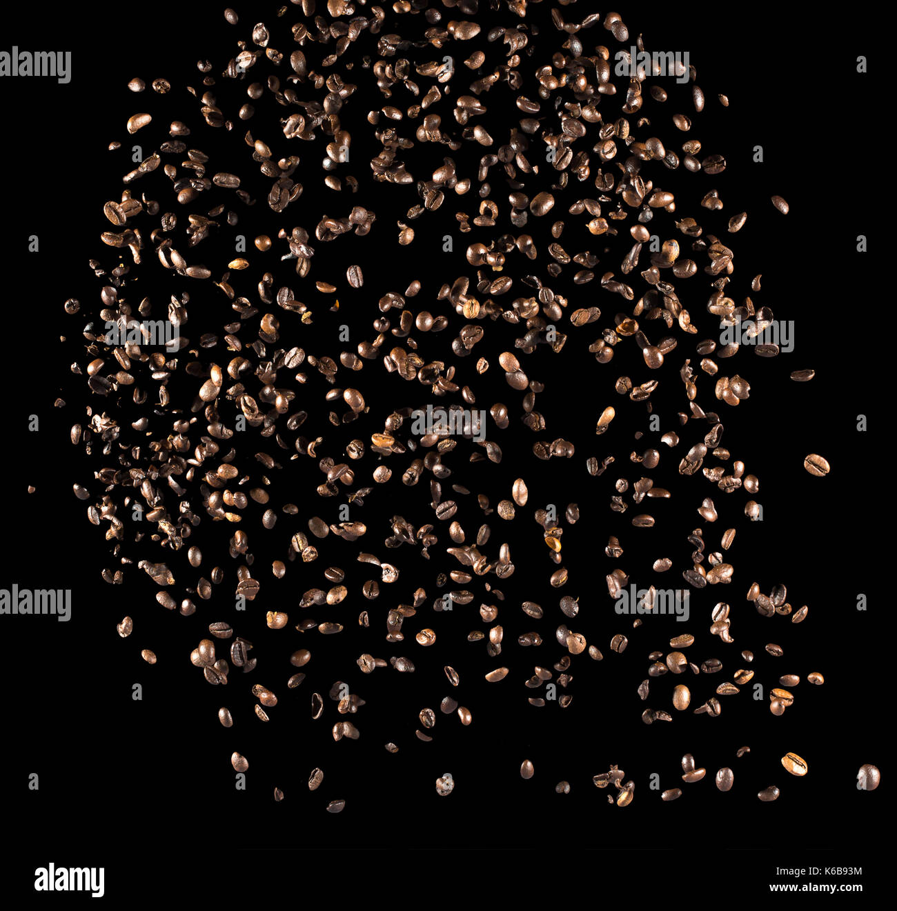 falling coffee beans on a black background Stock Photo - Alamy