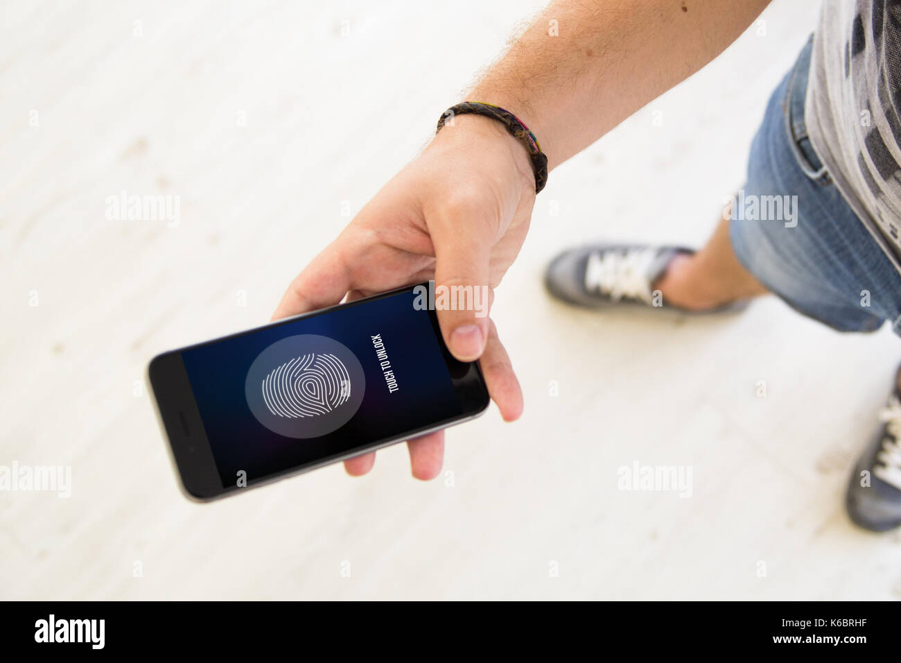closeup of male hand using smartphone fingerprint unlock app Stock ...