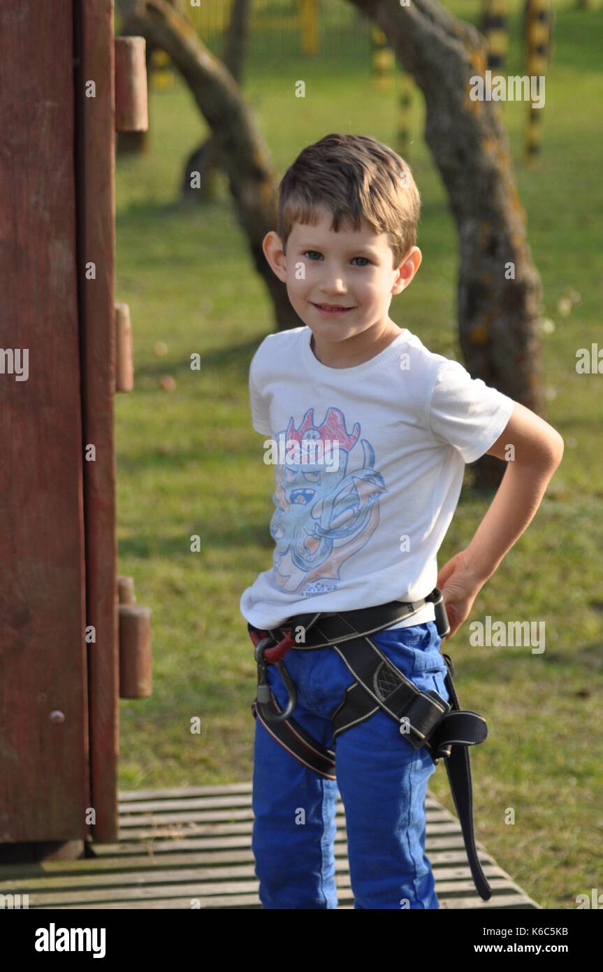 Boy climbing on the wall. Mountaineer in the harness Stock Photo - Alamy