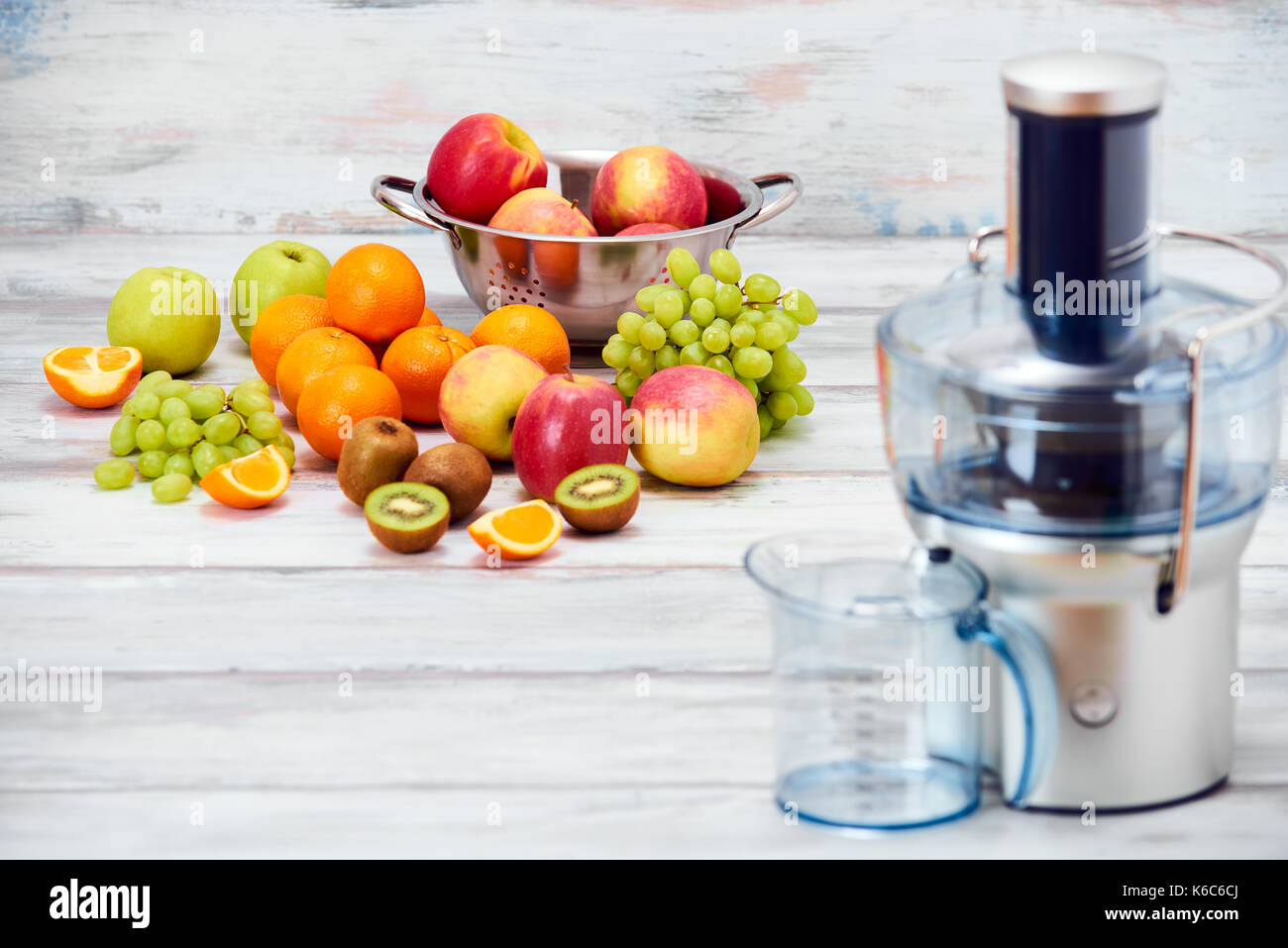 Modern electric juicer and various fruit on kitchen counter, healthy ...