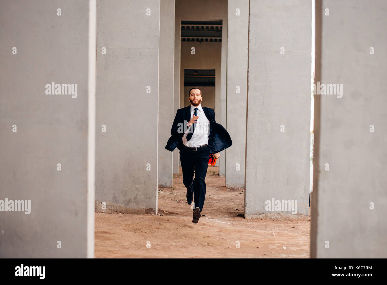 Construction worker running from danger on construction site Stock ...