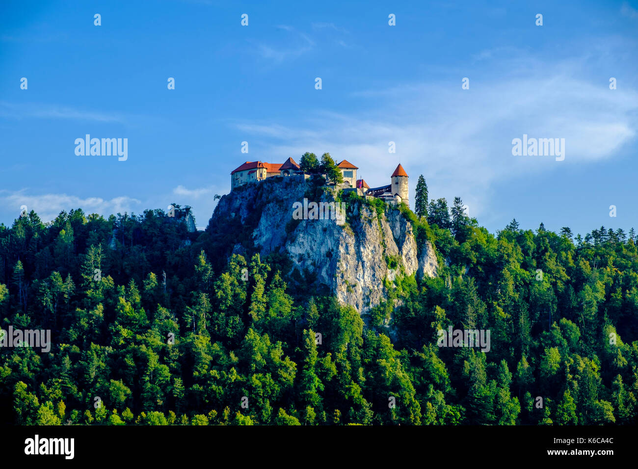 Bled Castle, Blejski grad, located on a rocky mountain, seen across ...